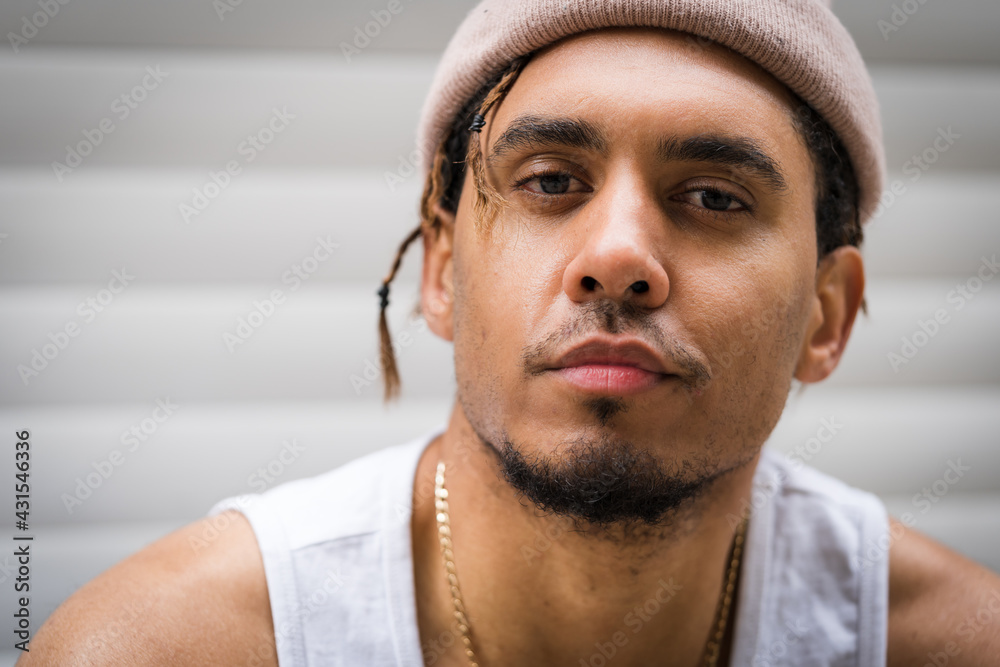 Model pose of a mixed race man looking directly at the camera. Portrait ...