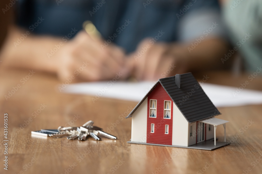 Crop close up of house cardboard mock-up model and keys to new home on ...