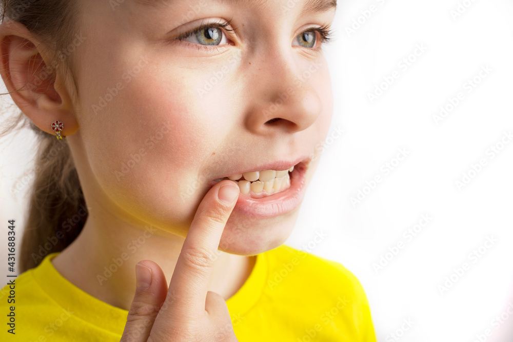 Little girl stands on a white background with a beautiful smile ...