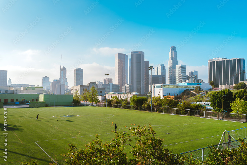 Green football field with views of downtown and high-rise buildings ...