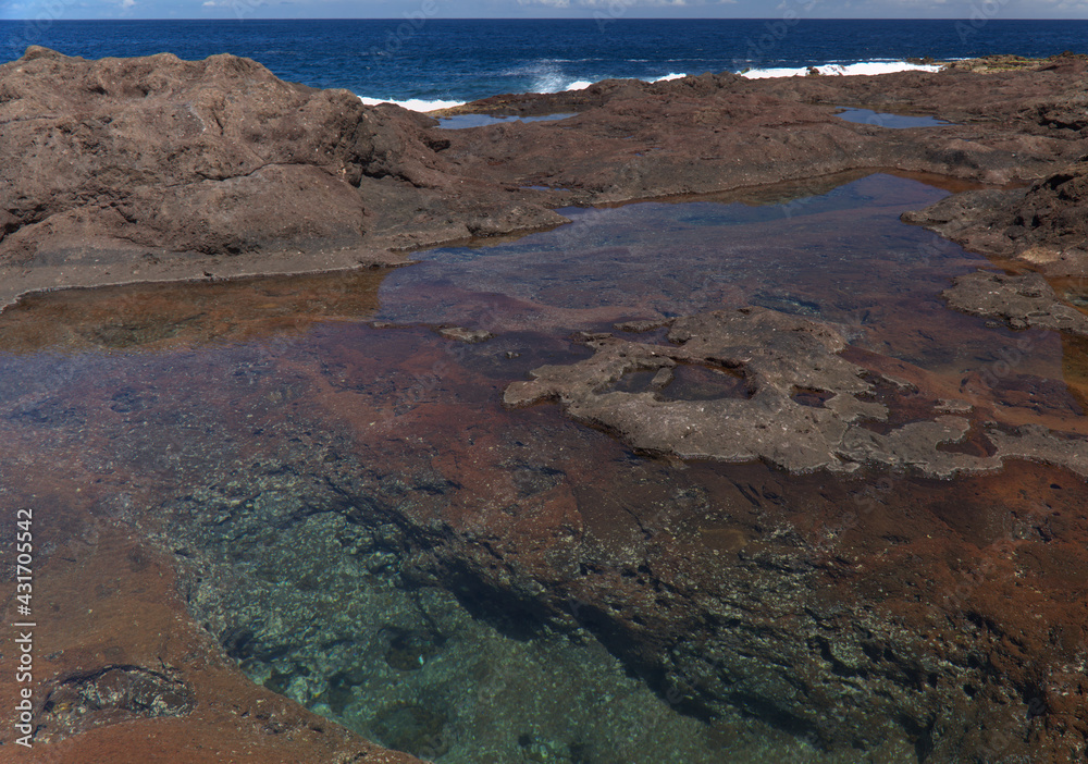 Gran Canaria, calm natural seawater pools in under the steep cliffs of ...