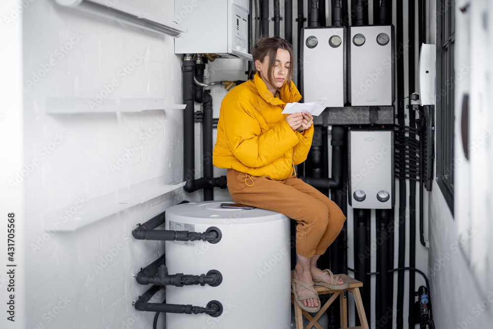 Confused woman looks at electricity bills, comparing data with the ...