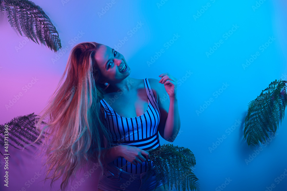 Dance party summer vibe. A model in neon poses. Fashion photo of a girl ...