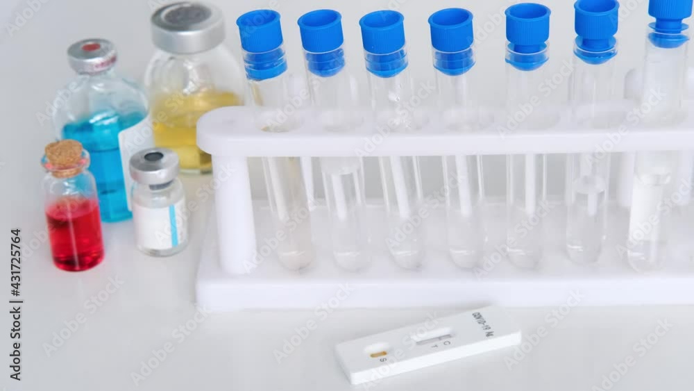 antigenic test cassette, glass tubes with reagents, a laboratory ...