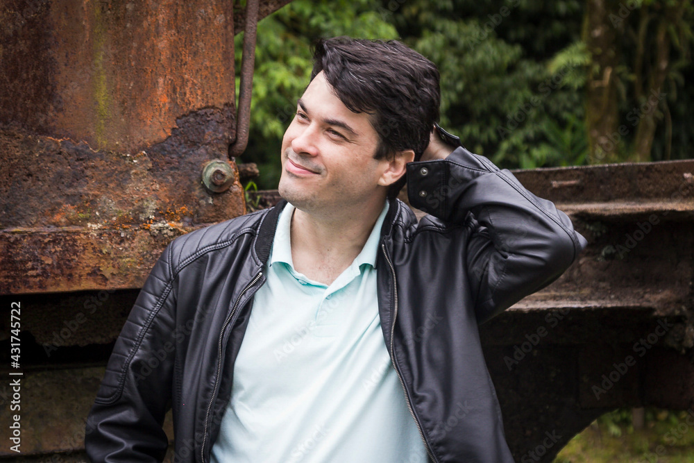 Young man of 30 years; running his hand through his hair; with a ...