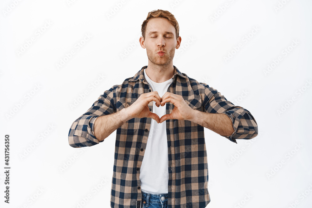 Cute and silly redhead masculine man showing heart sign, say I love you ...