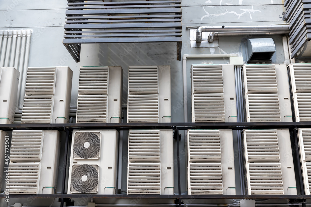 Air conditioner compressor installed in old building. Outdoor split ...