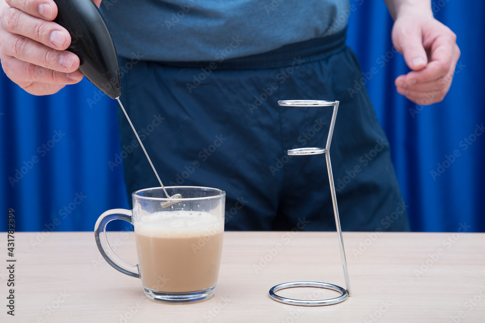 Making cappuccino coffee with a mixer at home. Stock Photo | Adobe Stock