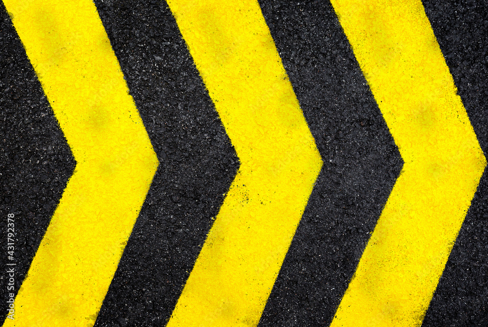 Top view of dark wet asphalt road with three yellow arrow signs. High ...