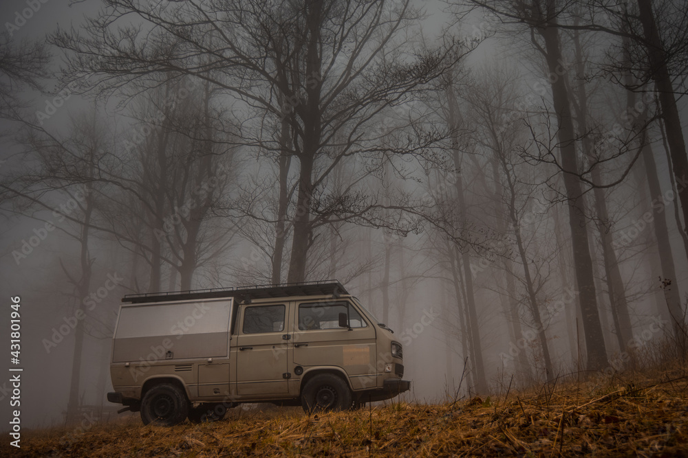 Vintage adventure campervan parked in a misty forest, adventourous and ...