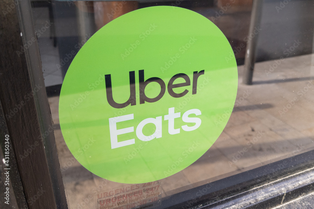Uber eats sign brand and text logo front of fastfood windows of ...