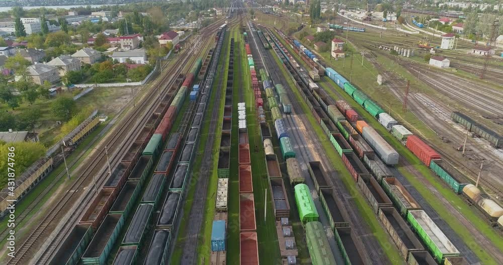 Freight trains stand at the railway junction top view. Fly over a large ...