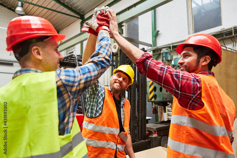 Group of craftsmen and workers at the high five Stock Photo | Adobe Stock