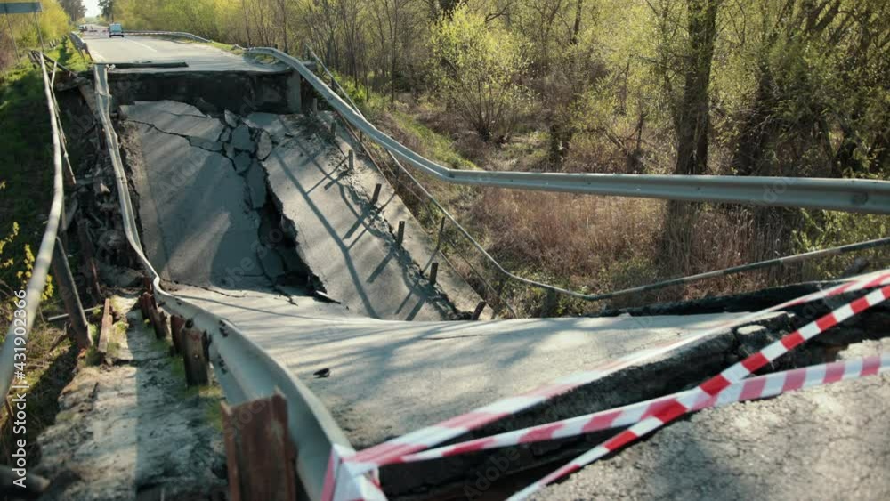 Flood damaged closed highway road, bridge. Cracked asphalt after ...