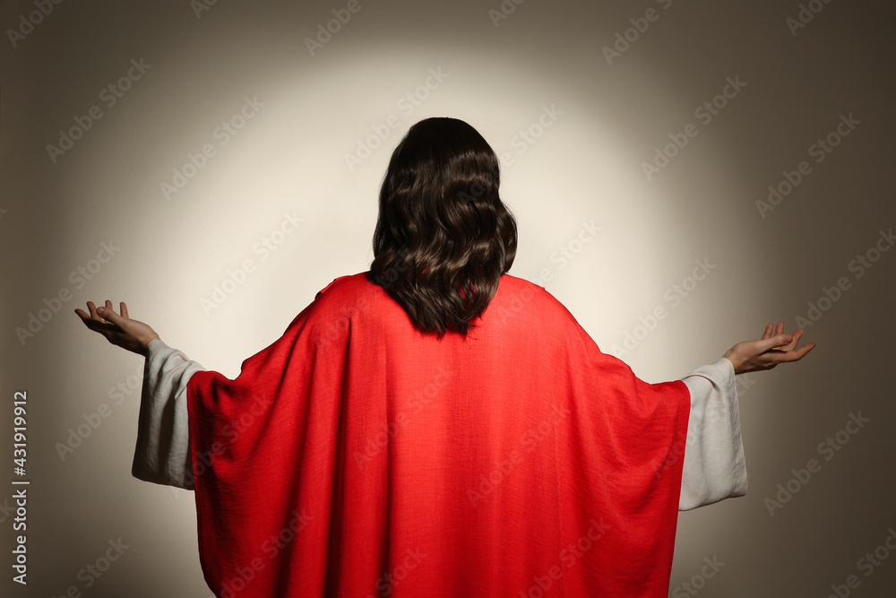 Jesus Christ with outstretched arms on beige background, back view ...