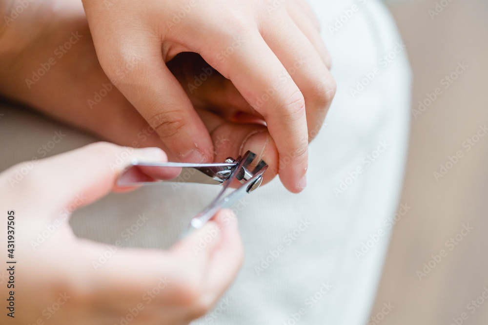 clean nails.kid child girl cutting nails using stainless steel nail ...