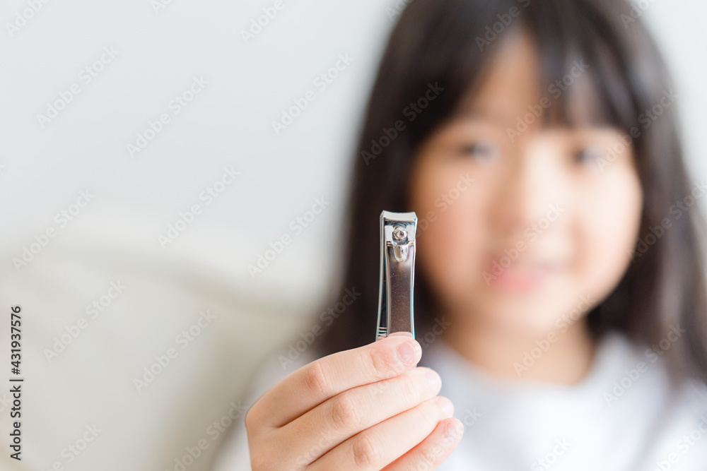 clean nails.kid child girl cutting nails using stainless steel nail ...