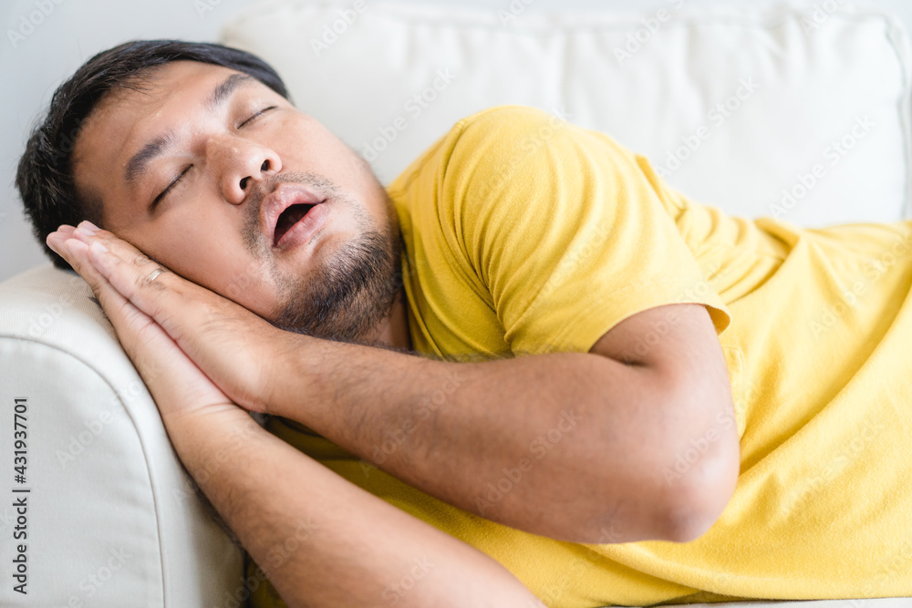 Asian man take a nap on sofa with snore.take nap daydreaming in living ...