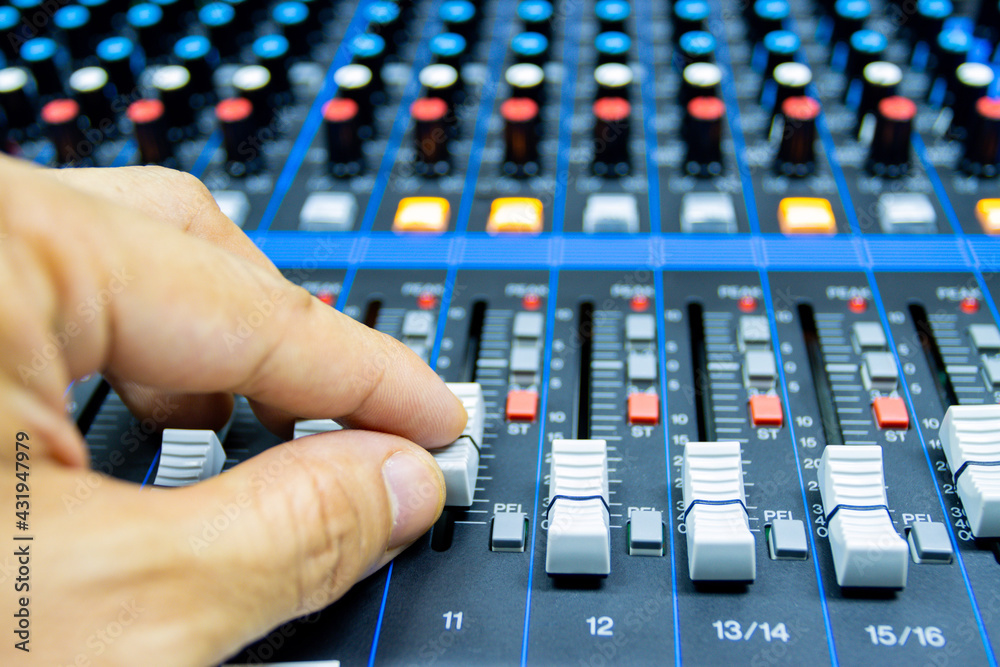 hands of Men are controlling the console of a large hi-fi system. Sound ...
