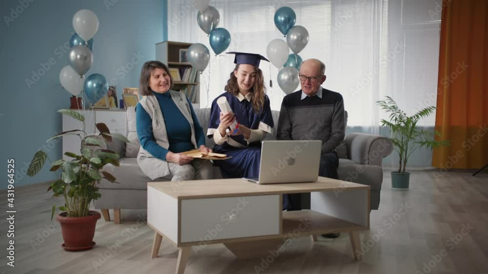 family with their graduate daughter holding diploma celebrate ...