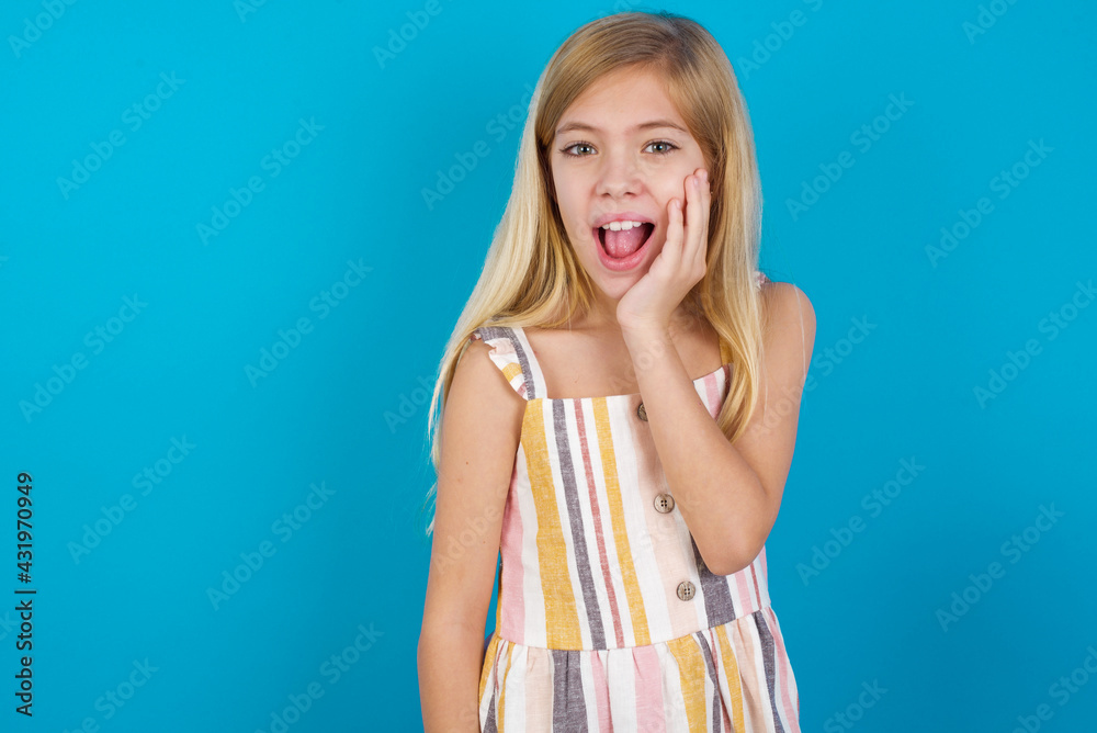 Shocked, astonished beautiful Caucasian little girl wearing stripped ...