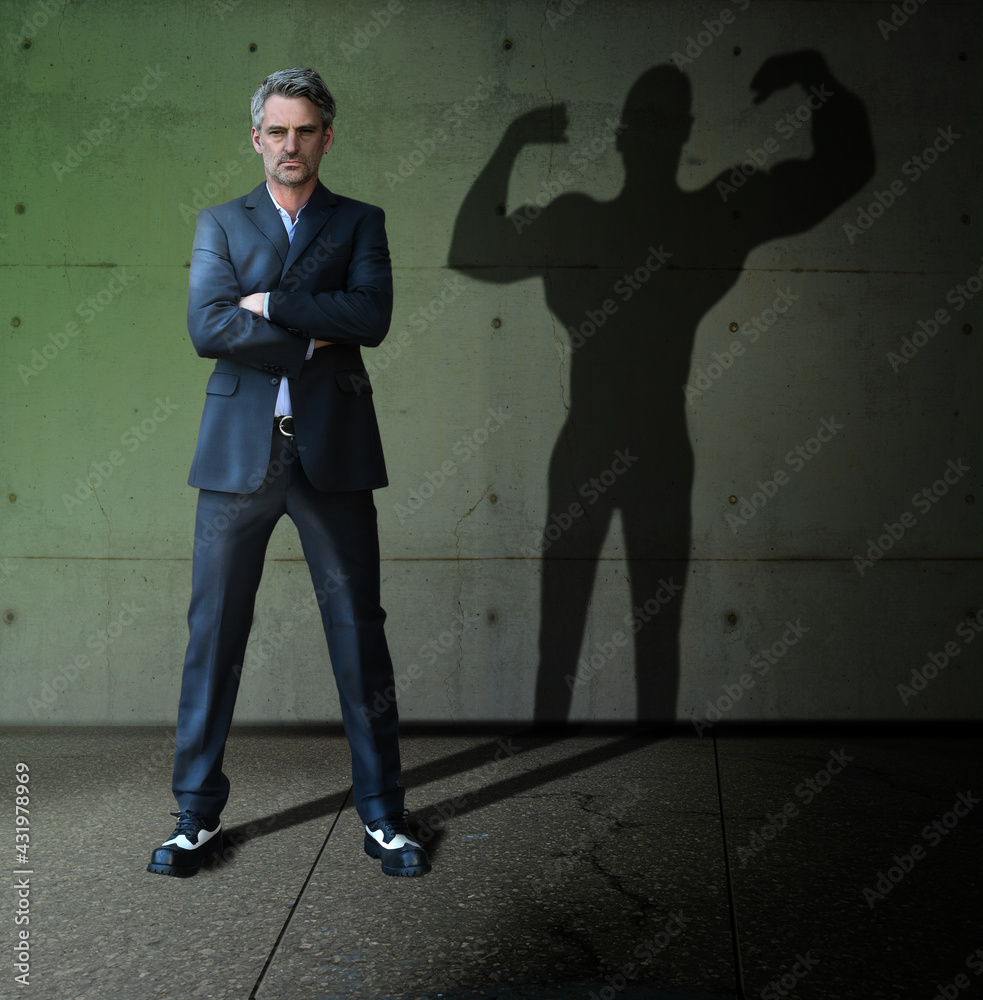 Super leader business man in a suit with strong man shadow - self ...
