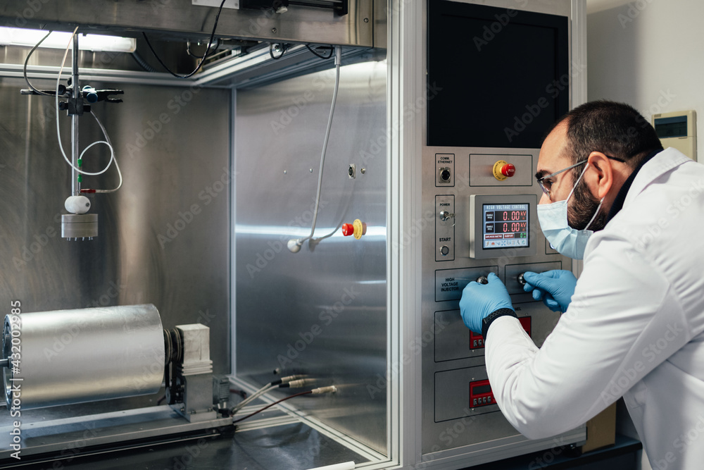 lab technician testing nanofiber on an electrospinning machine ...