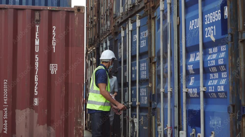 Asian business woman in suit jacket holding clipboard and dock worker ...
