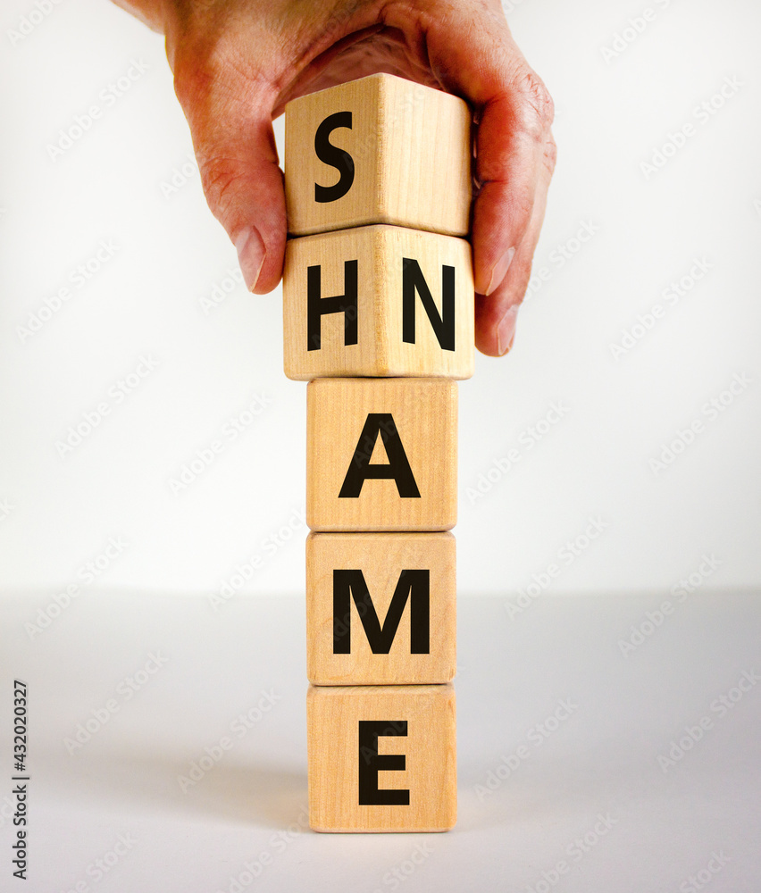 Name or shame symbol. Businessman turns wooden cubes and changes the ...