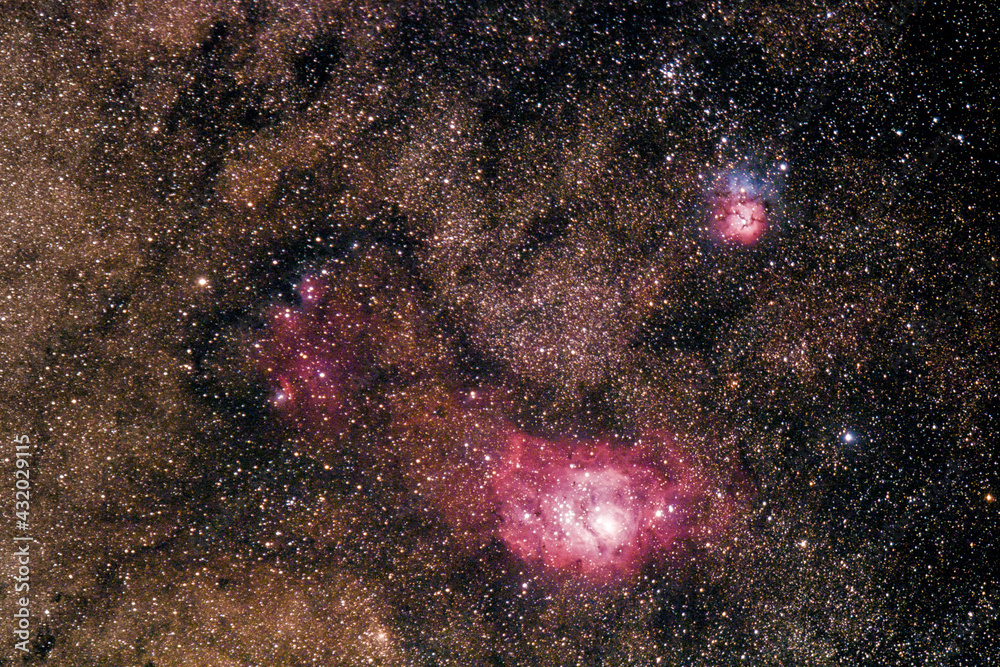 M8, the Lagoon Nebula, resting below M20, the Trifid Nebula in the ...