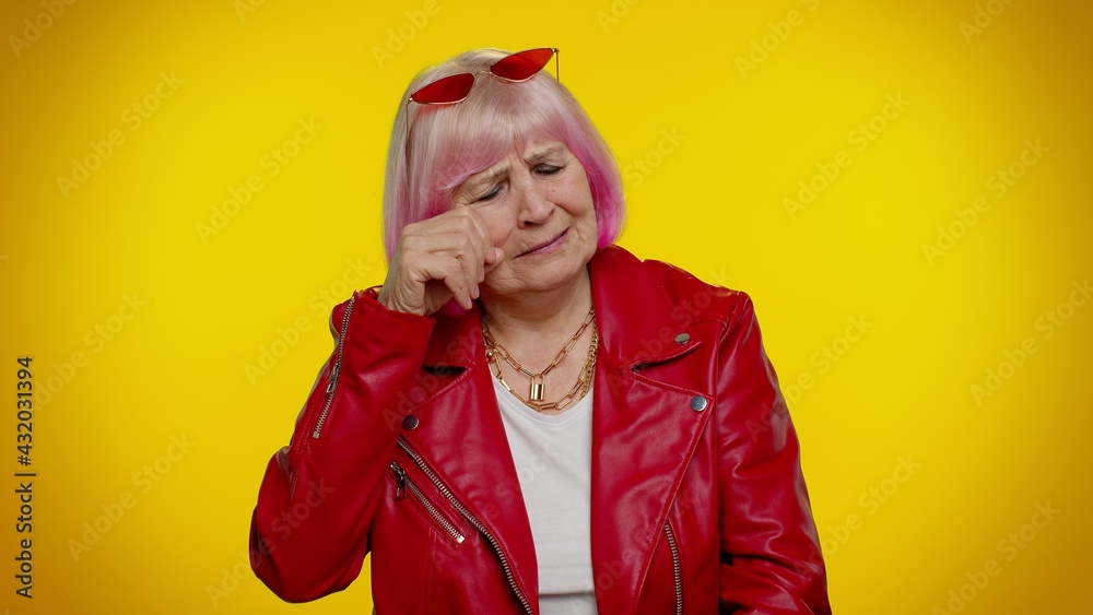 Upset disappointed senior old rocker granny woman wipes tears and cries ...