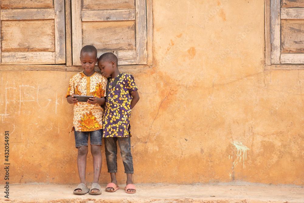 african kids using a smartphone, playing games and watching videos ...