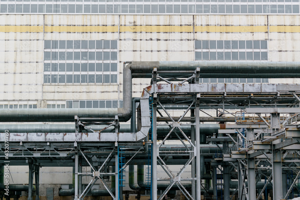 Industrial pipes on metal supports. Various diameters of many pipes ...