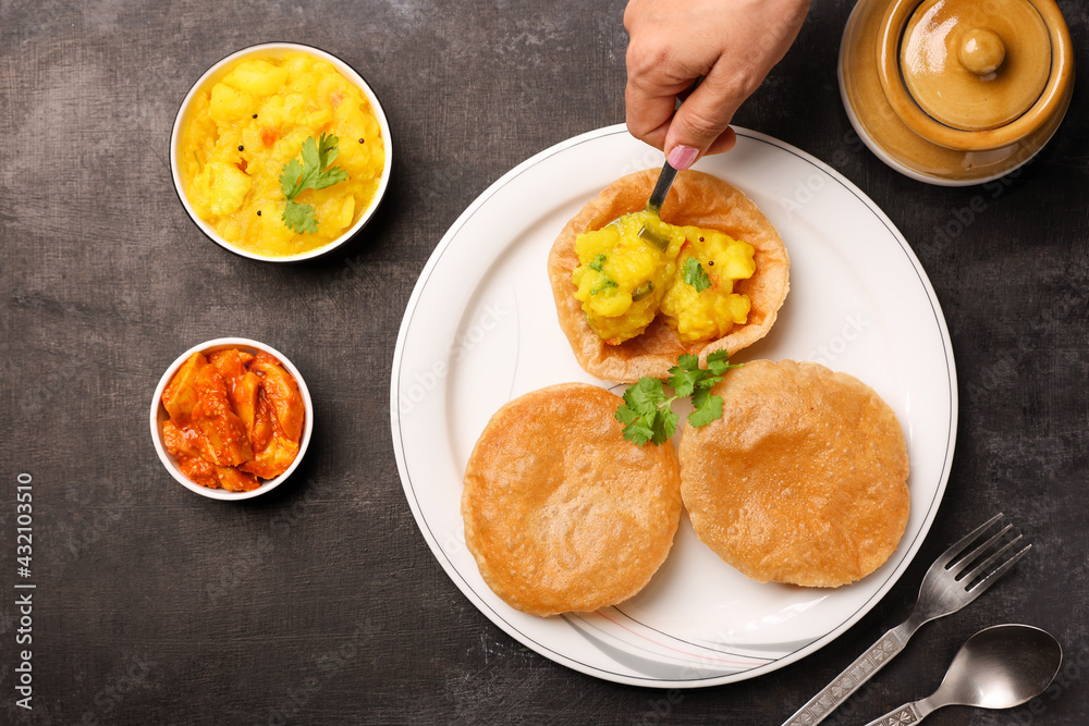 Hand serving Puri Bhaji North Indian Poori with aalu bhaji , aalu sabji ...