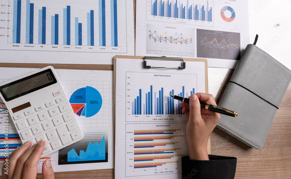 Business people or accountants are analyzing graphs on finance ...
