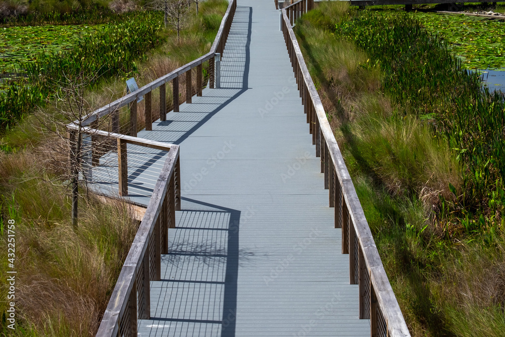 A long grey modern metal walkway or path with aluminum railing on the ...