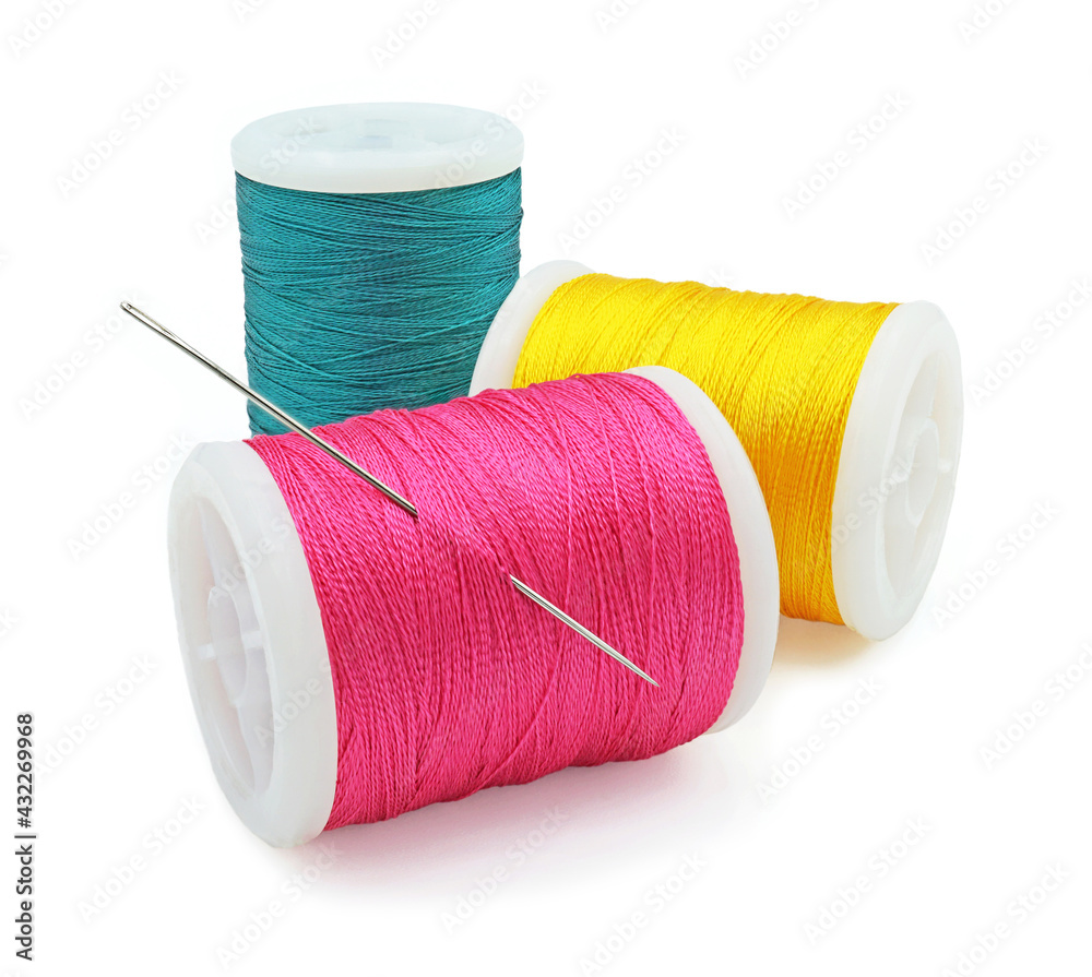 Spool of pink yellow and green thread with needle, Bobbins thread ...