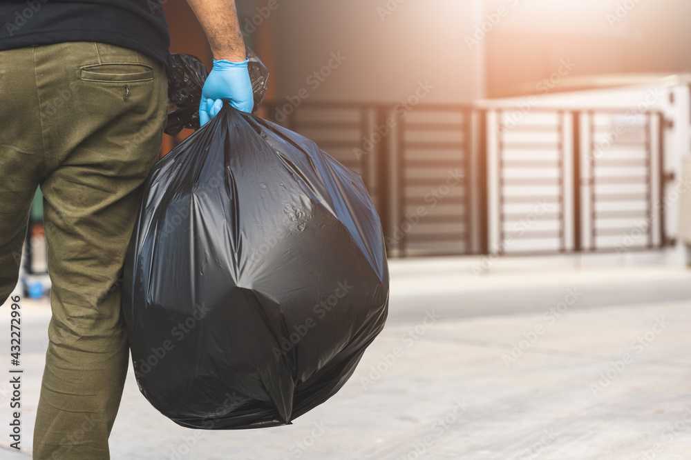 The young man separated the dangerous waste into a large black bag and ...