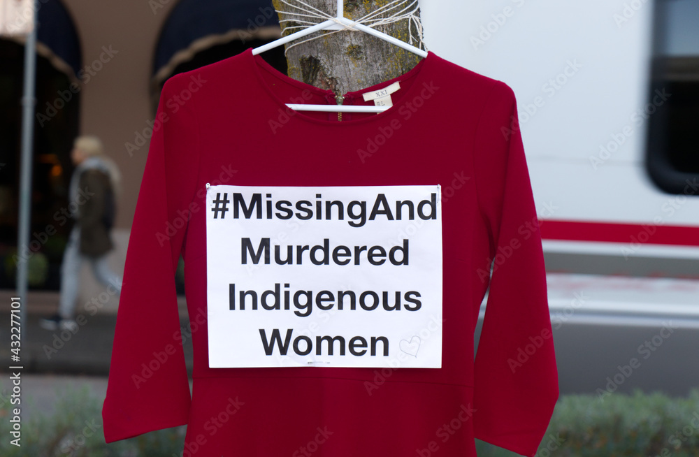 A red dress with text "Missing And Murdered Indigenous Women" is ...