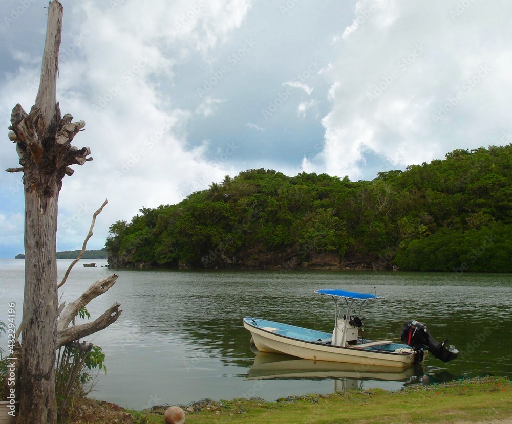 Motor boat docked in a small cove in Ngarchelong State, Palau. Stock ...