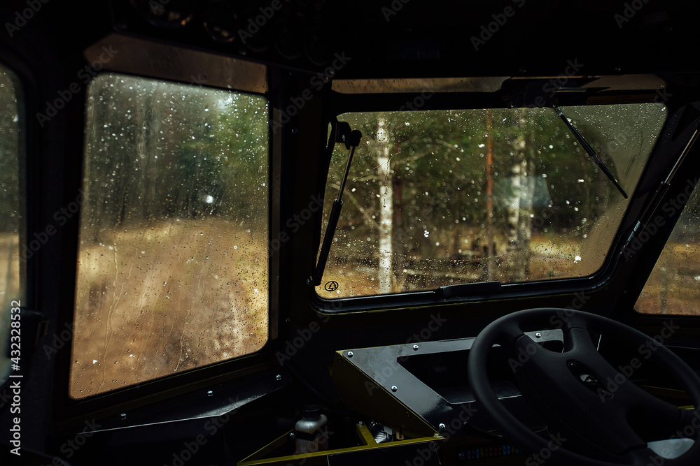 the driver is driving off-road. view from the interior of a four-wheel ...