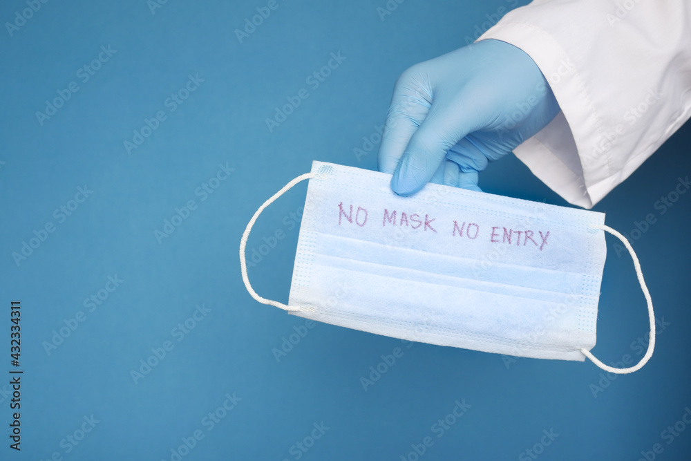 blue surgical masks on table, no mask no entry concept Stock Photo ...