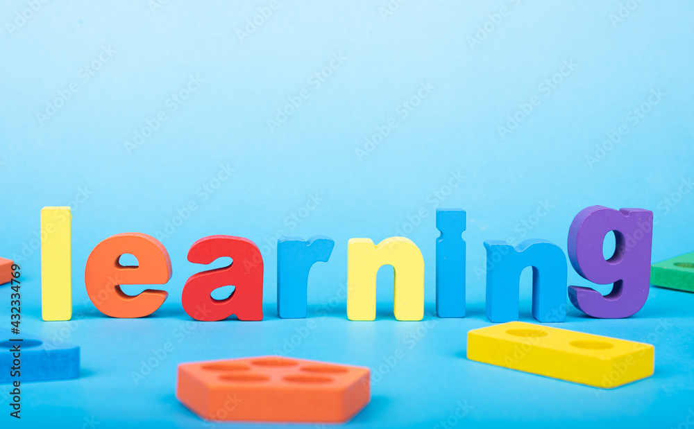 Learning word written with wooden alphabets blocks on blue chart kids ...