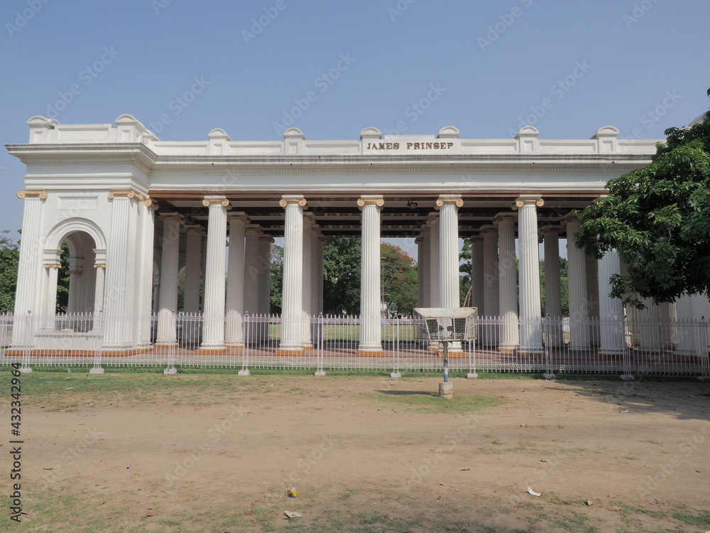 Prinsep Ghat surrounded by a garden under the sunlight and a blue sky ...
