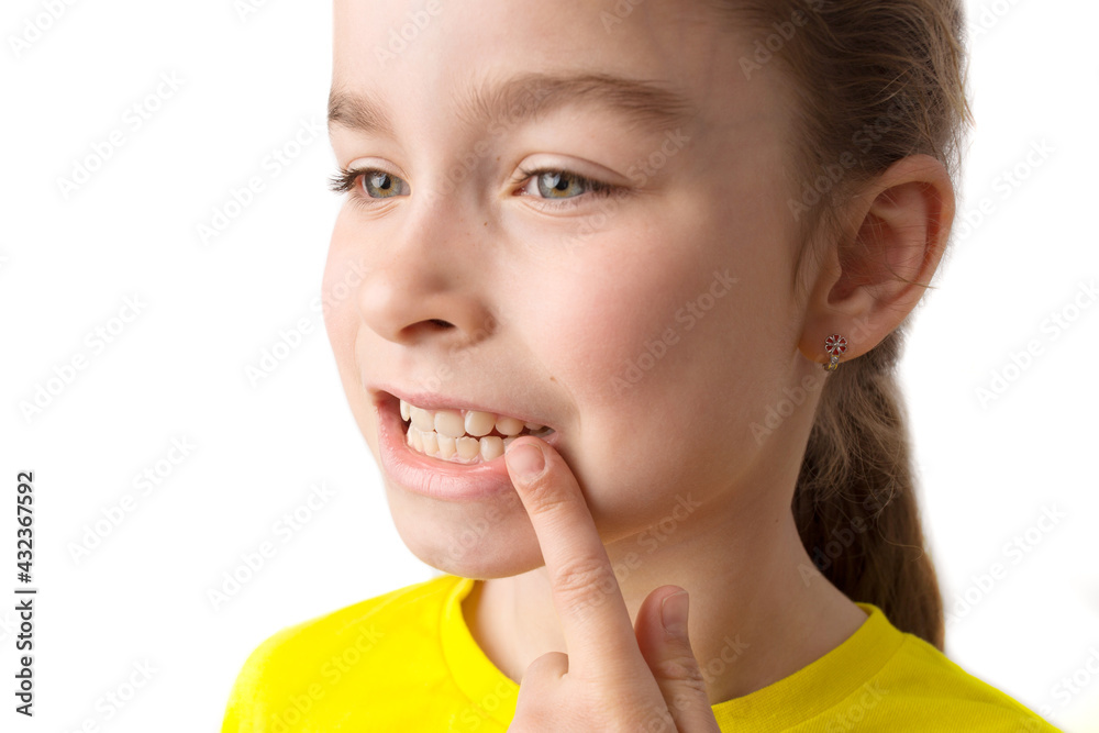 Little girl stands on a white background with a beautiful smile ...