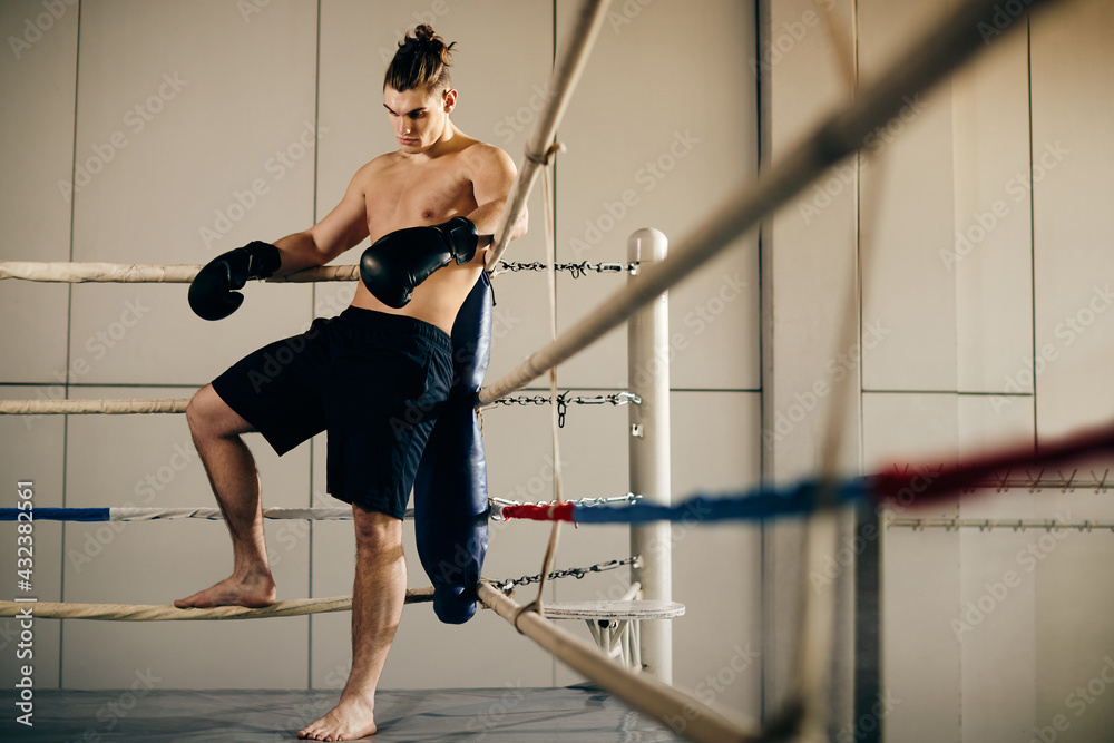Full length of muscular build fighter resting in boxing corner. Stock ...