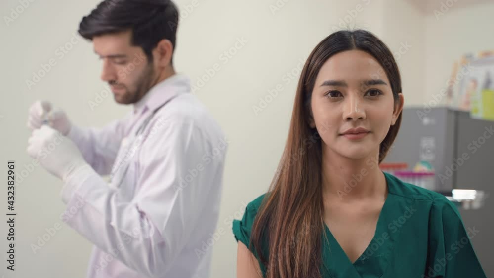 Slow Motion Video - Medical young in safety gloves is making a vaccine ...