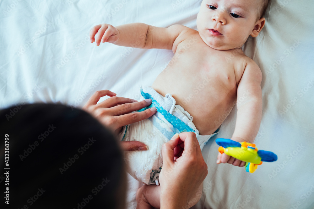 Top View of Little Baby Looking at his Mommy while she is Changing his ...