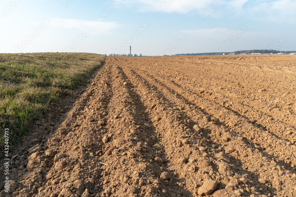 Deep furrows in the ground after working the tractor with the plow ...