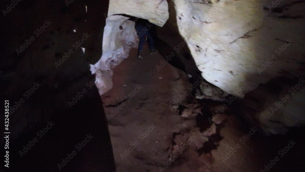 Underground cave with stalactite rock formations hanging from Twins ...